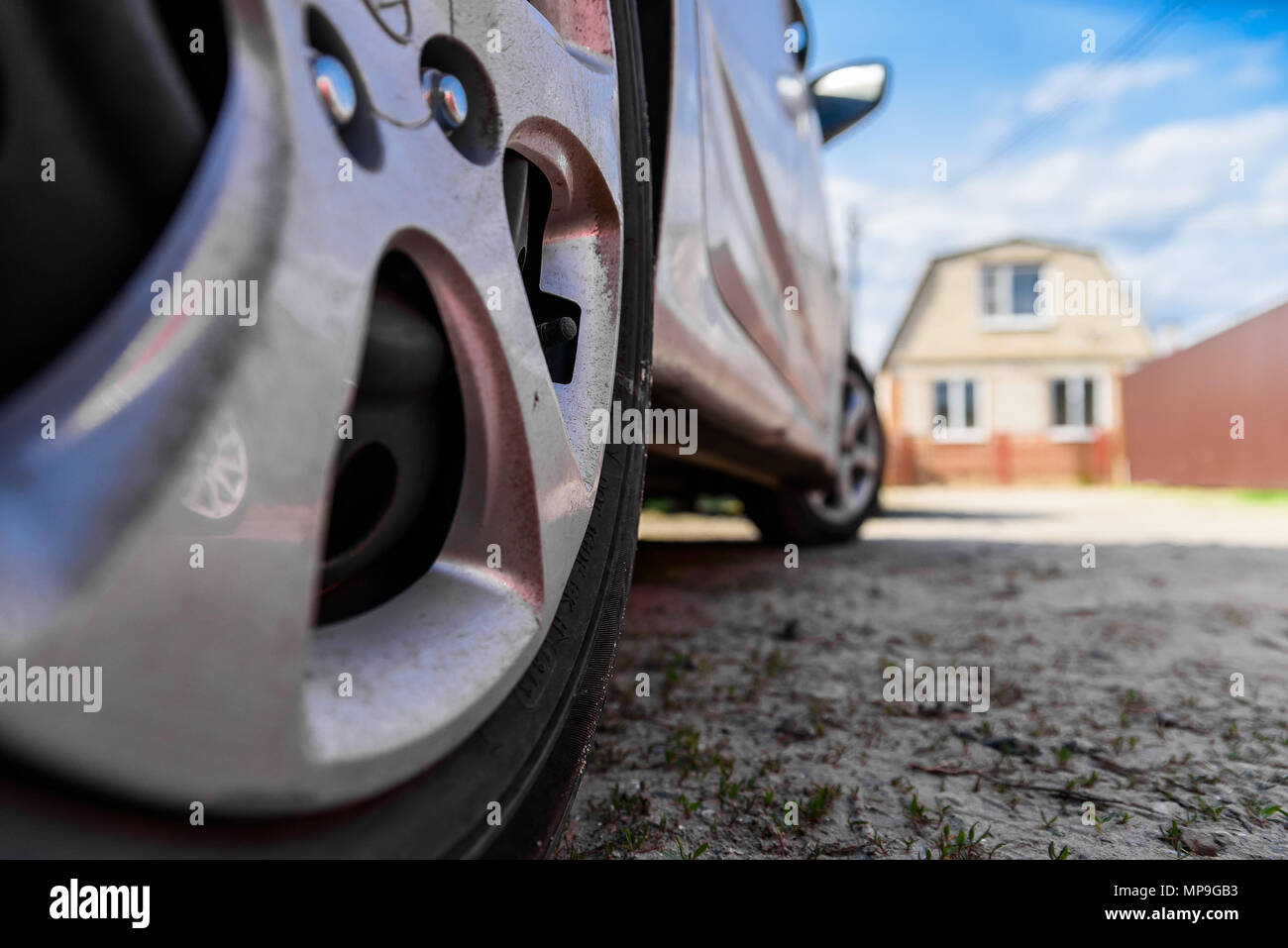 Rear wheel of car parked in country close Stock Photo - Alamy