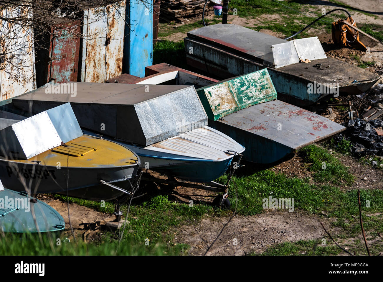 Old metal boats stored on coast Stock Photo - Alamy