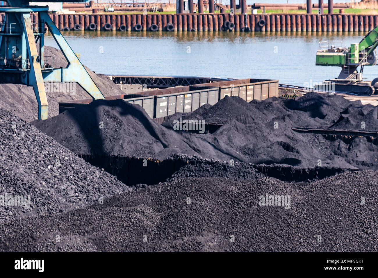 Piles of coal in industrial sea port Stock Photo - Alamy