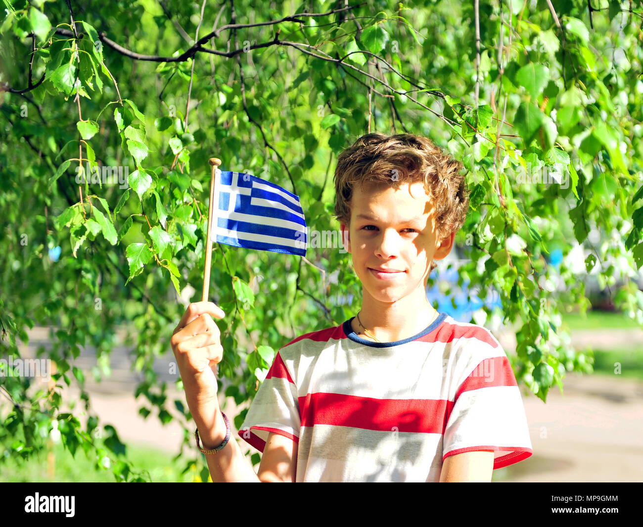 Cheerful teenager with flag of Greece outdoors Stock Photo - Alamy