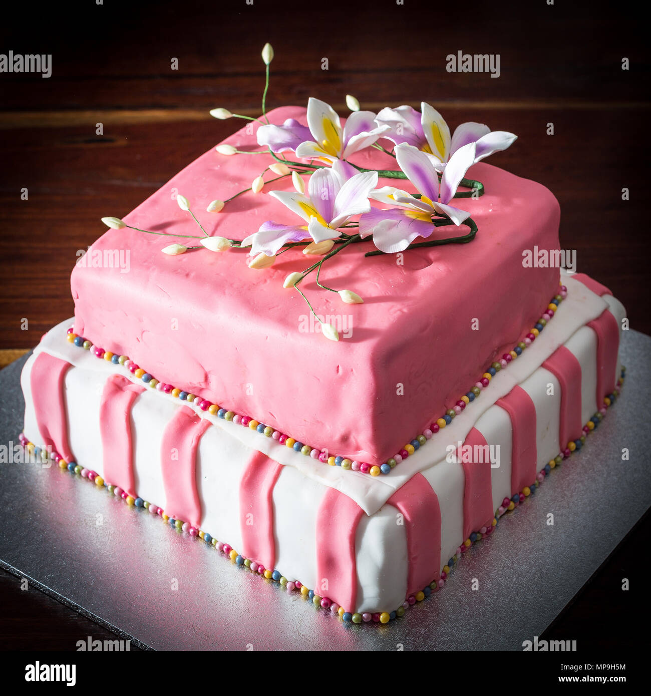 Home made cake with pink and white fondant icing Stock Photo - Alamy