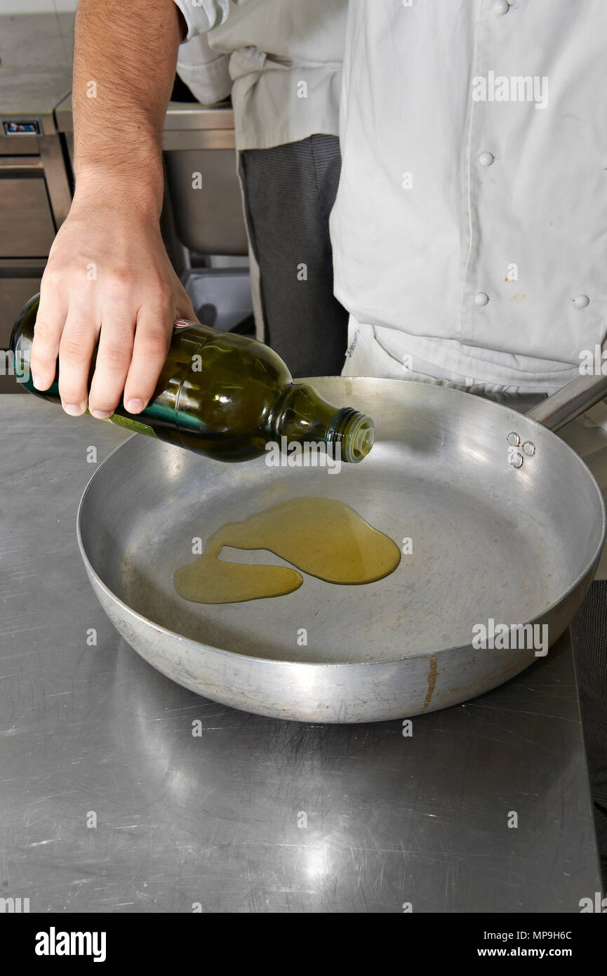 pouring olive oil in a pan Stock Photo - Alamy