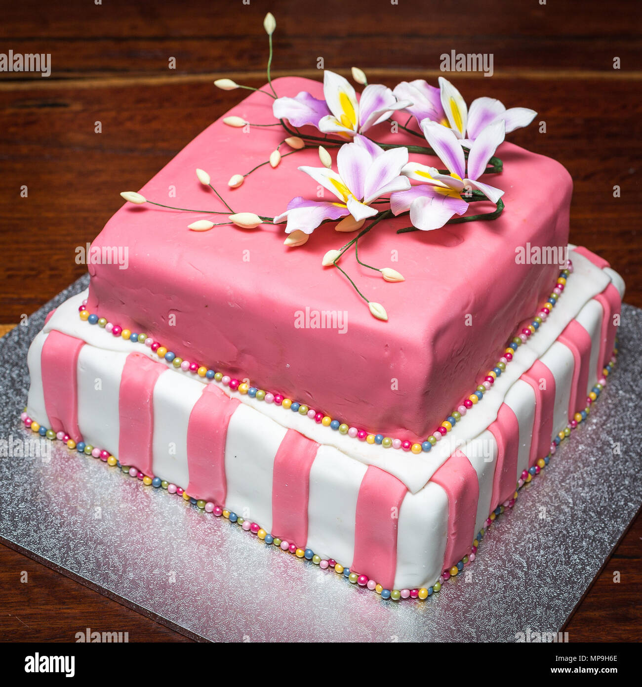Home made cake with pink and white fondant icing Stock Photo - Alamy