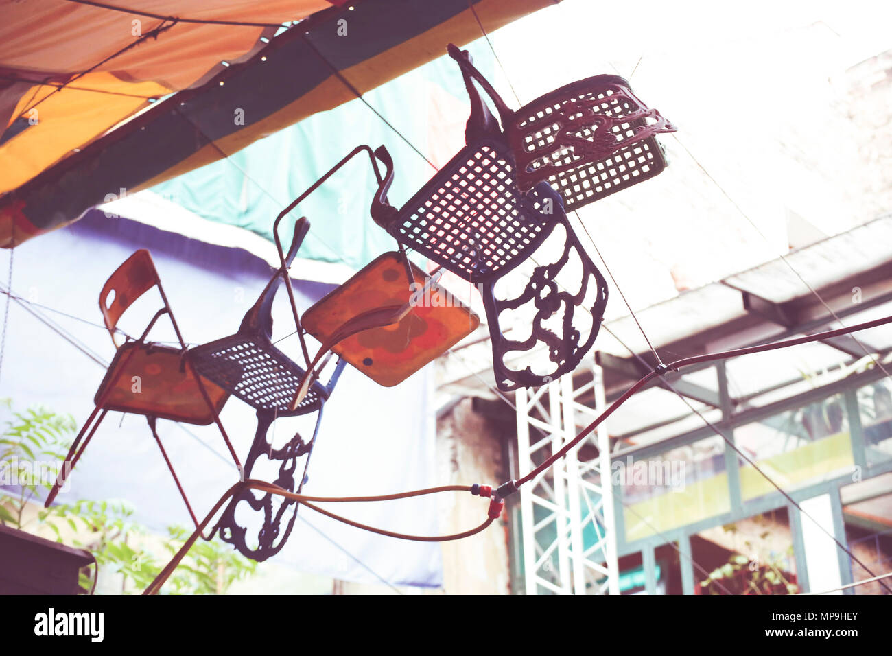 Strange chairs flying in the air Stock Photo - Alamy