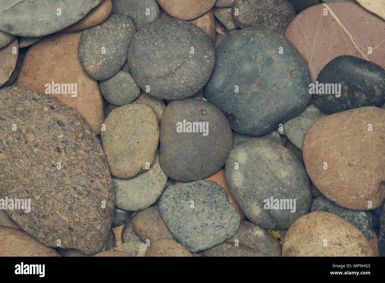 Pile of pebble stones for background Stock Photo - Alamy