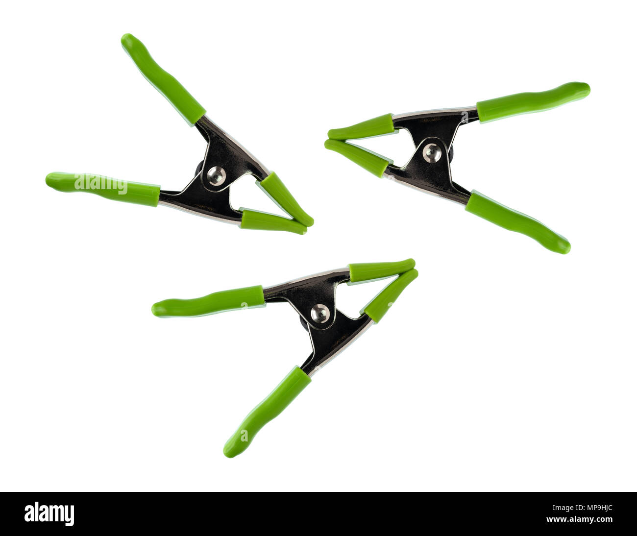 Top view of three metal spring clamps with green plastic protectors ...