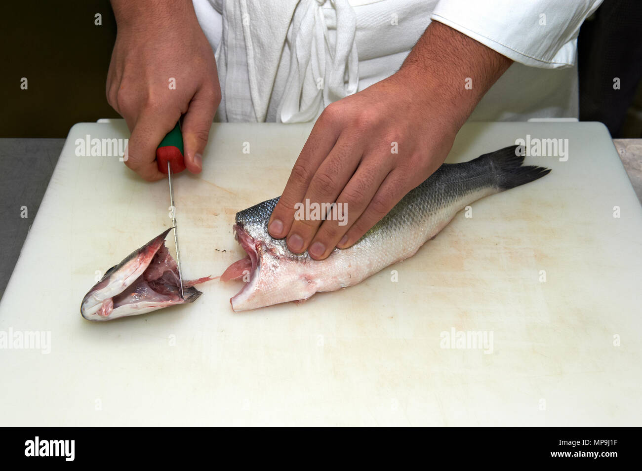 the cleaning of the sea bass Stock Photo - Alamy