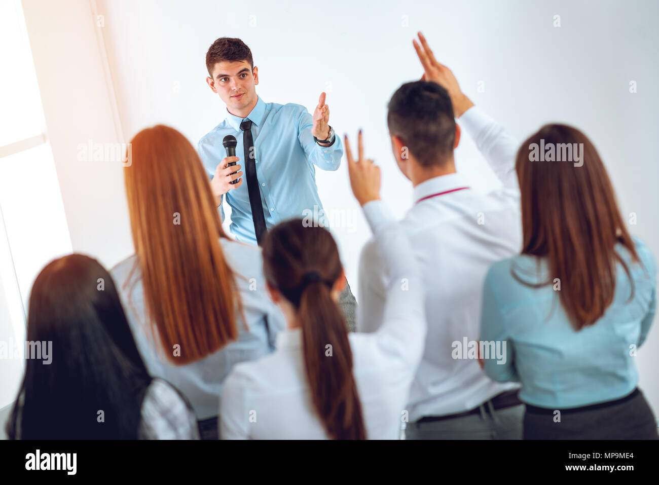 Young businessman explaining to her colleagues plan of work. The team ...