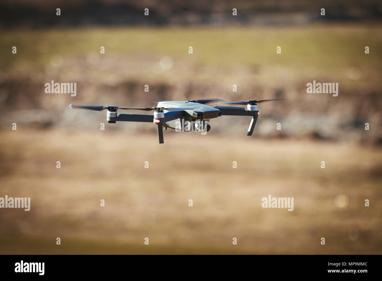Drone take off from land and flying above field, for take aerial photo ...