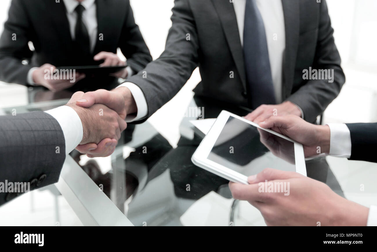 close up. business people handshake over the Desk Stock Photo - Alamy