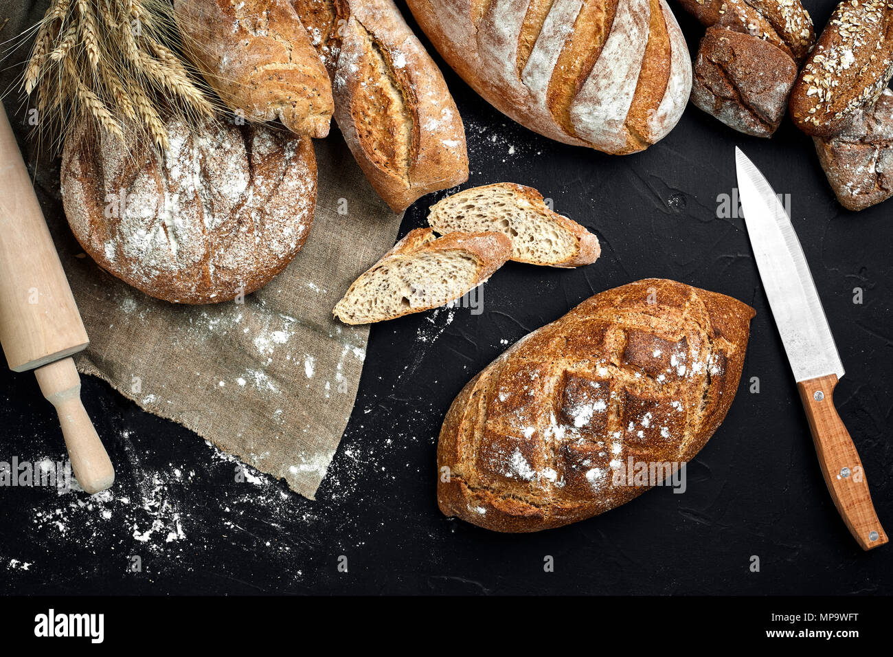 Mixed breads on black table. Top view with copy space Stock Photo - Alamy