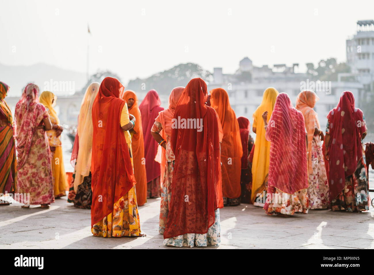 Beautiful and colorfully dressed Indian women mourn a death and wash ...