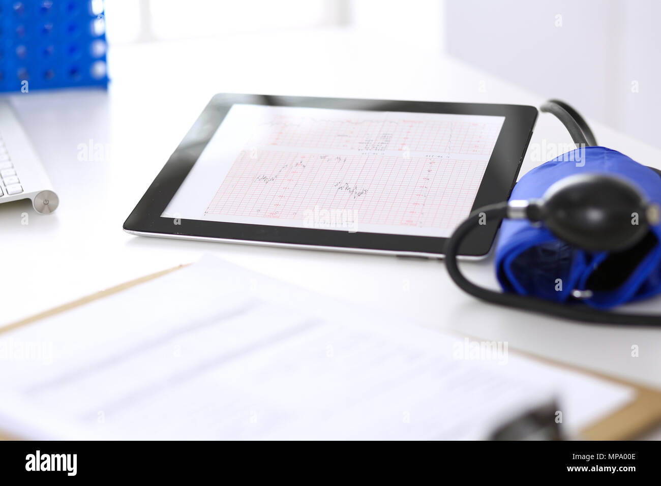 Workplace of doctor. Tablet ps showing heart diagrams closeup ...