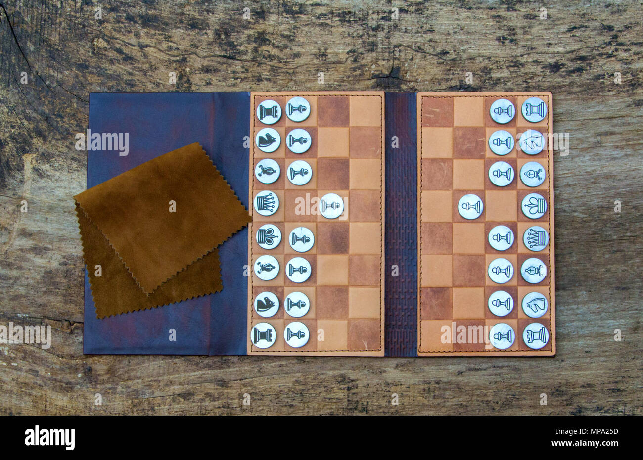 Leather chess table on the wooden background with metal figures Stock ...