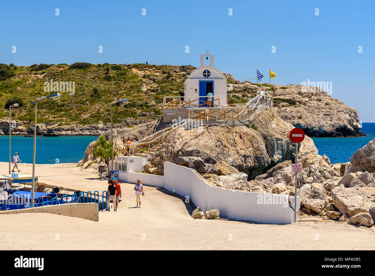 RHODES, GREECE - May 12, 2017: Tourists visit Greek chapel in Kolymbia ...