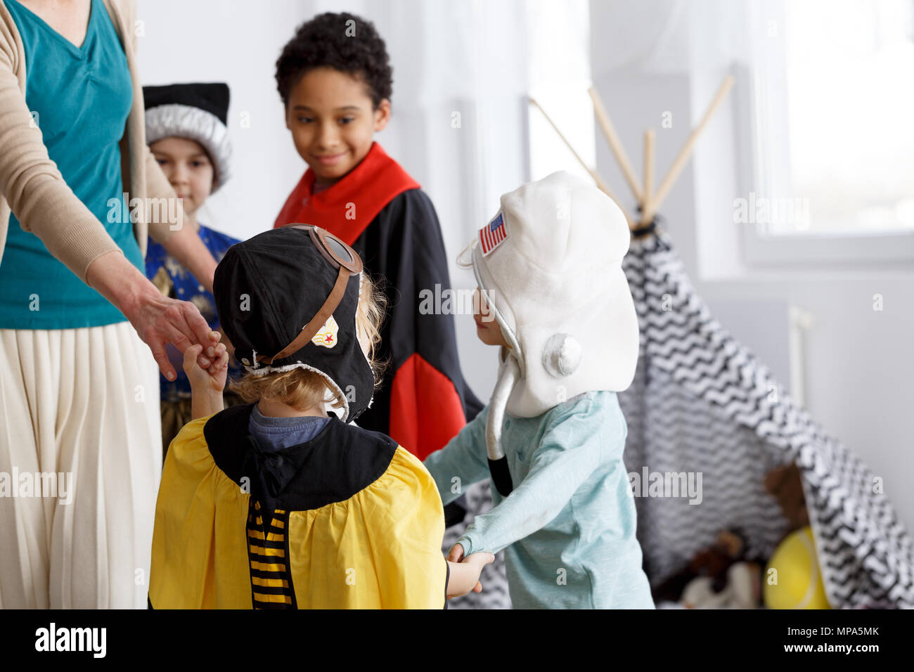 Group of children in costumes dancing in a circle Stock Photo - Alamy