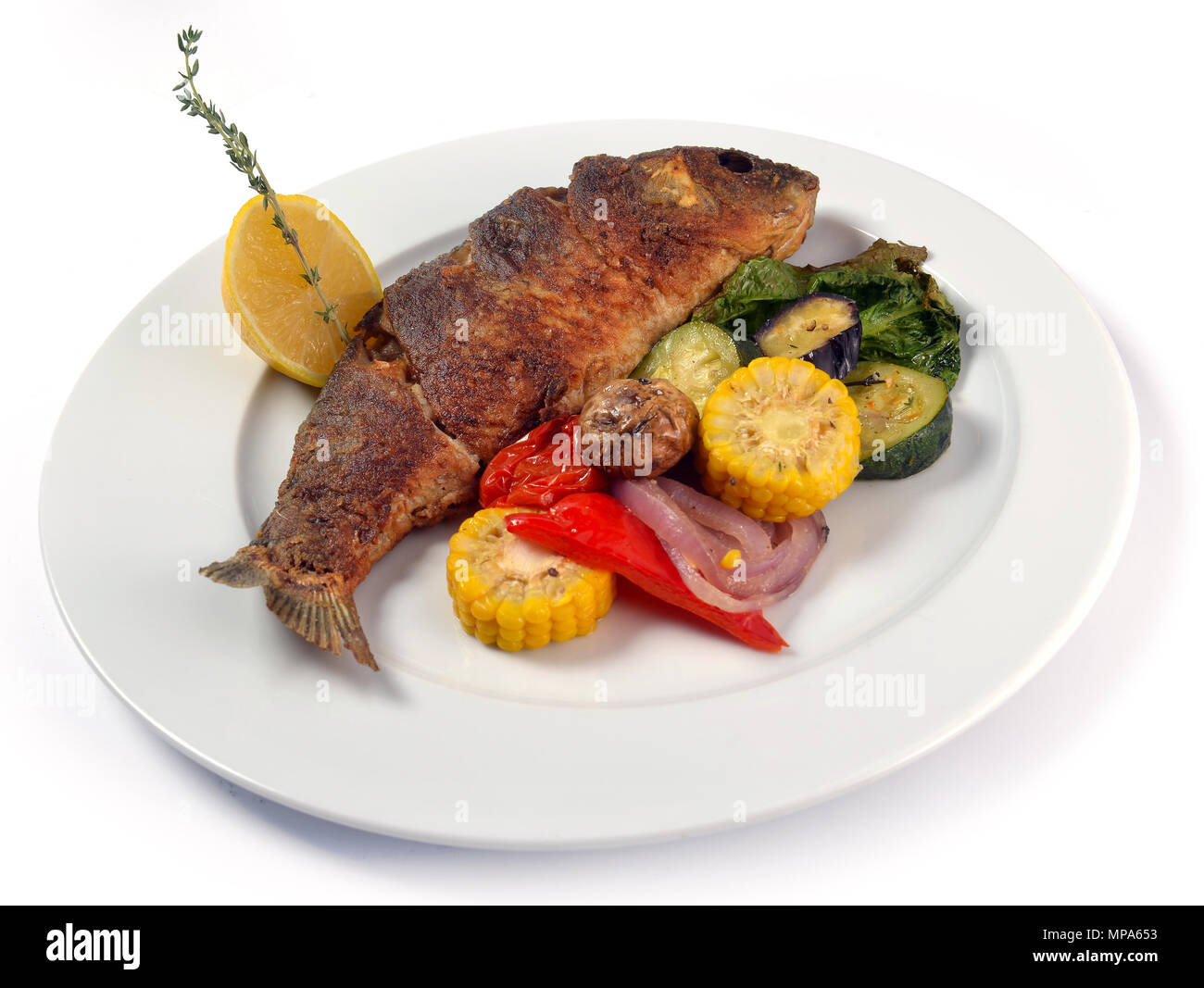 grilled dorado with vegetables in white plate Stock Photo - Alamy