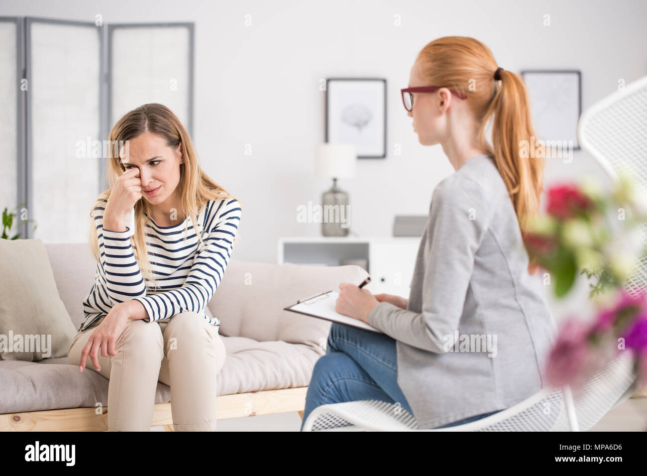 Woman crying during therapy session hi-res stock photography and images ...