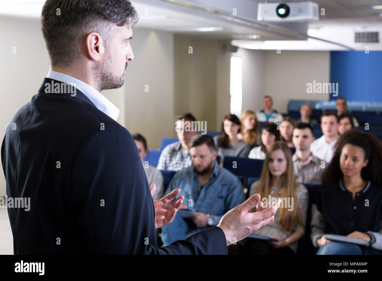 Group of university students and young professor in suit Stock Photo ...