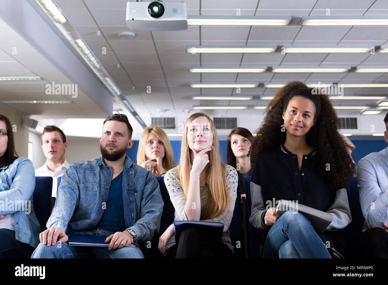 Group of students sitting in lecture hall Stock Photo - Alamy