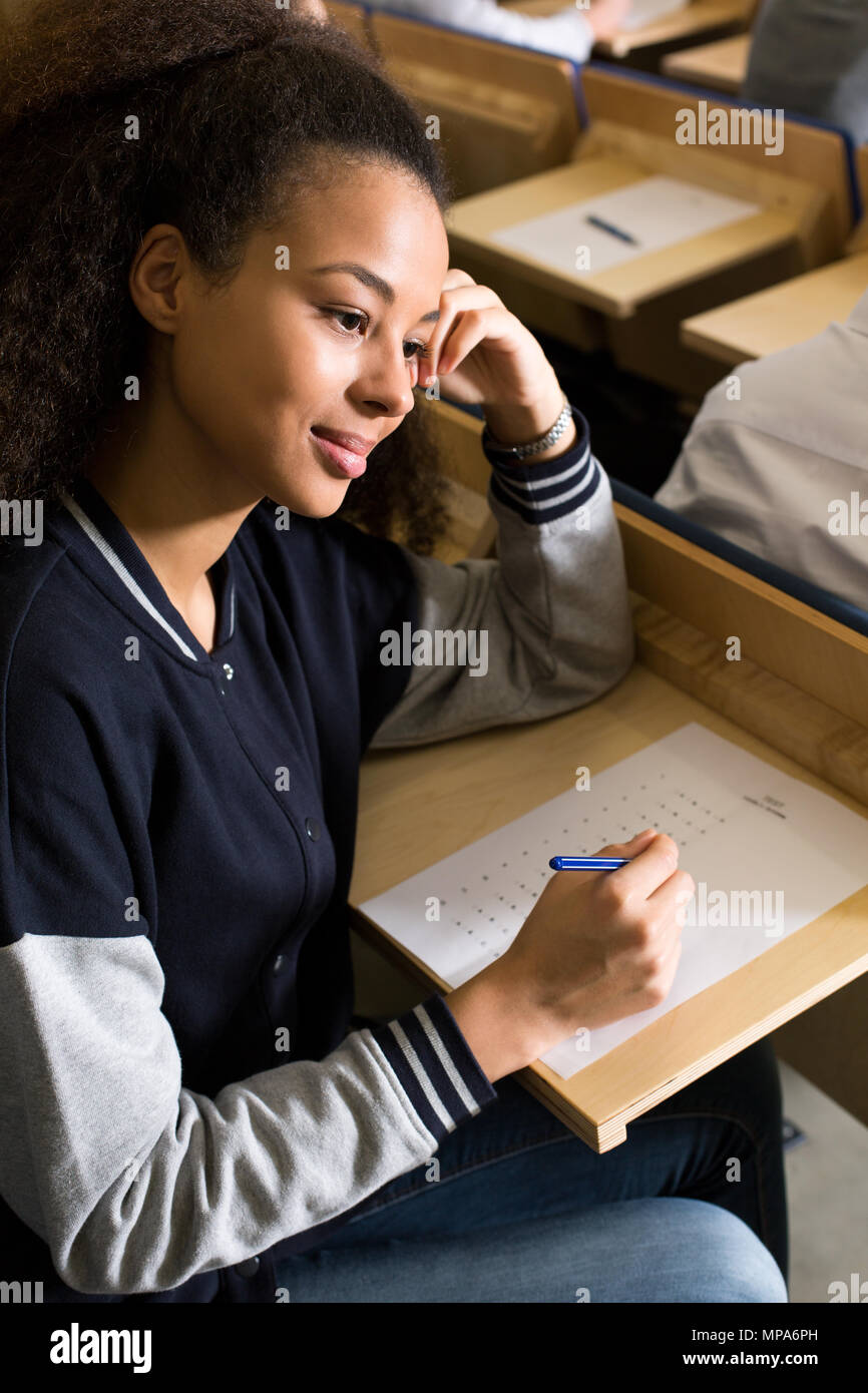Young woman sitting in lecture hall during lecture Stock Photo - Alamy