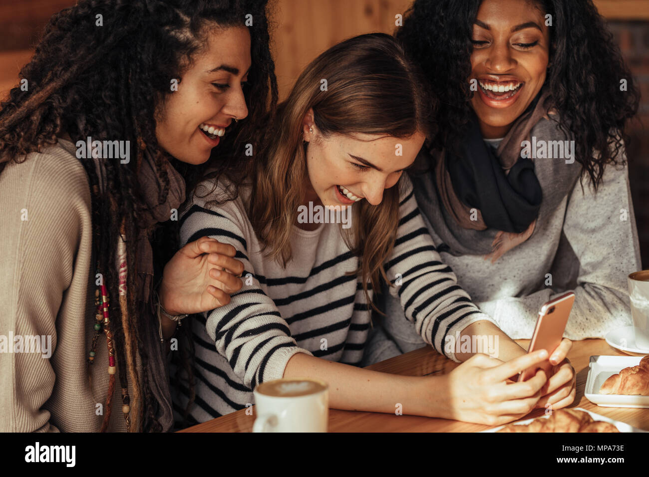 Women laughing restaurant table hi-res stock photography and images - Alamy