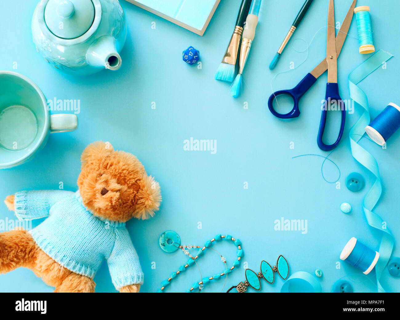 Flat lay blue color objects and accessories frame on light blue ...