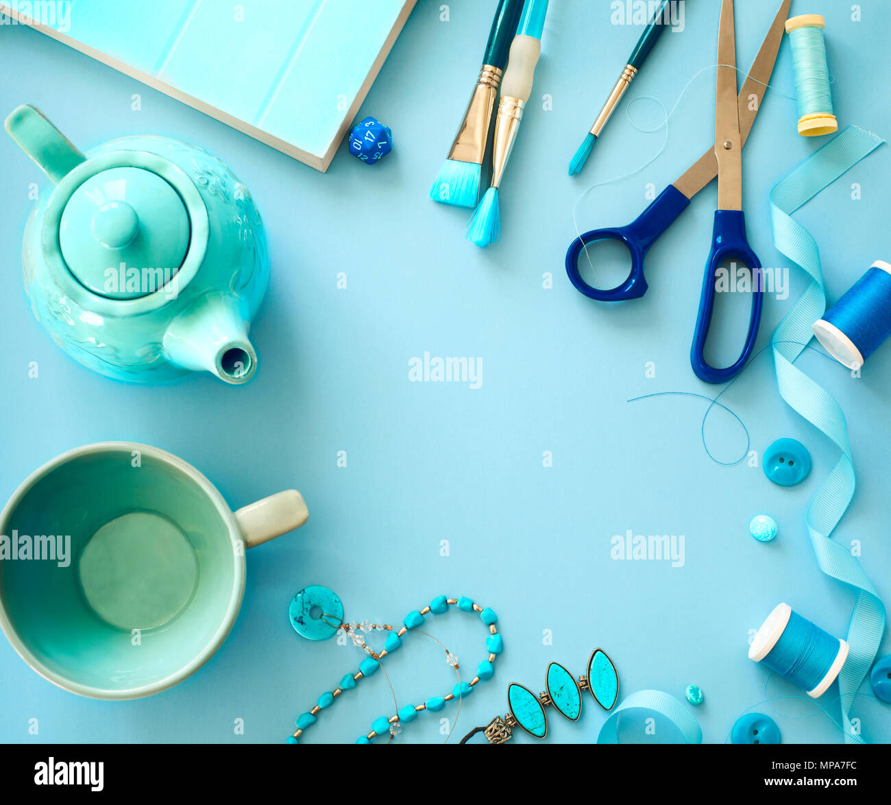 Flat lay blue color objects and accessories frame on light blue ...