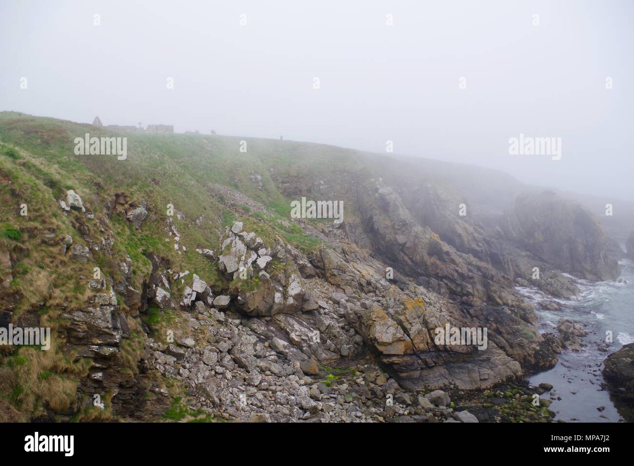 Rugged Grassy Coastal Cliff Under Thick Sea Fog Haar. Cove Bay ...