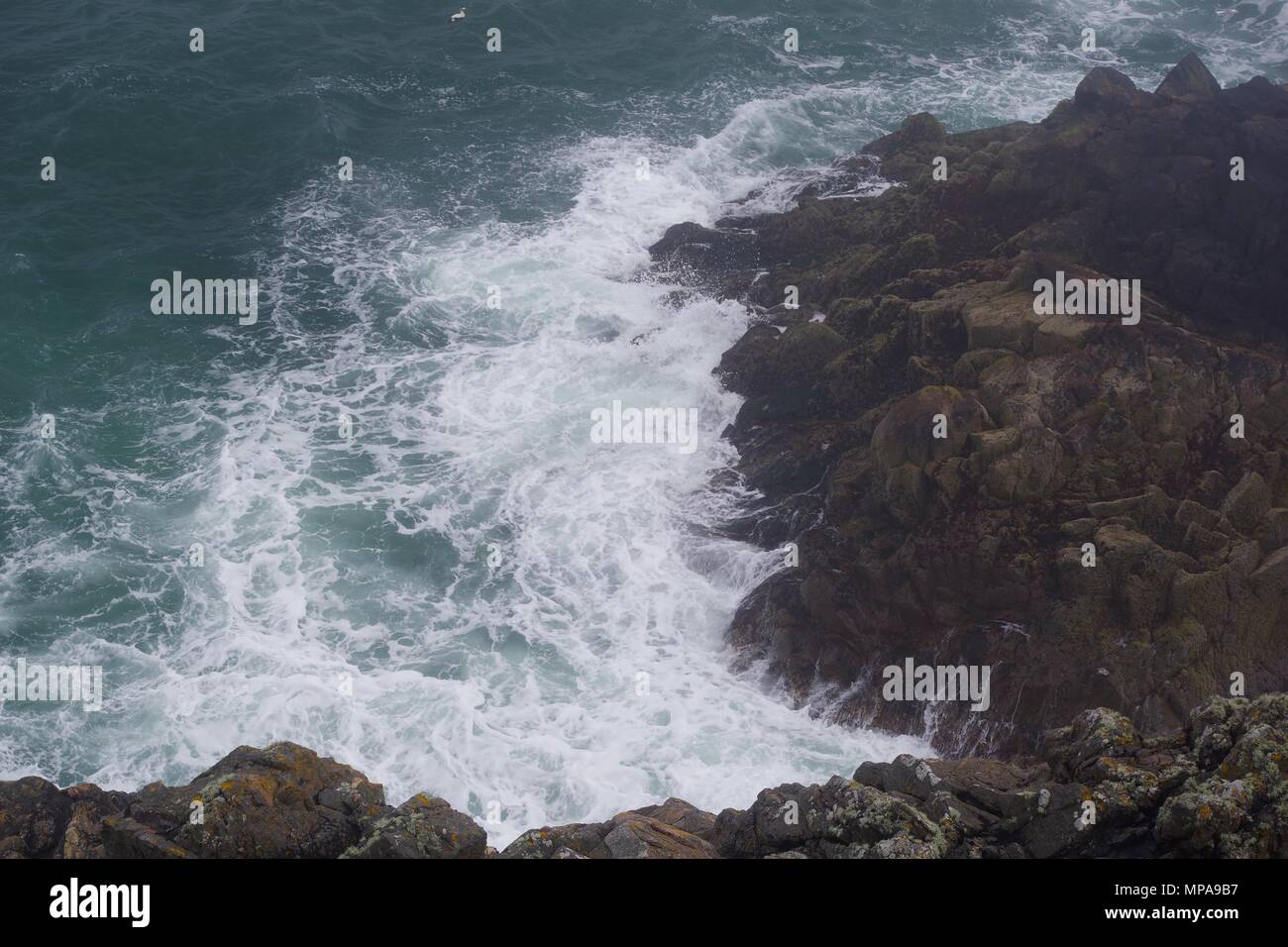 Eerie North Sea at the Base of Rugged Cliffs under a Thick Sea Fog ...