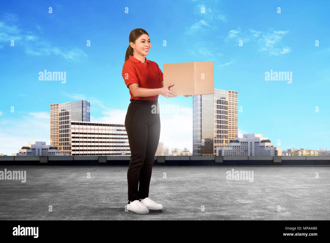 Happy asian delivery woman deliver the parcel in the city Stock Photo ...
