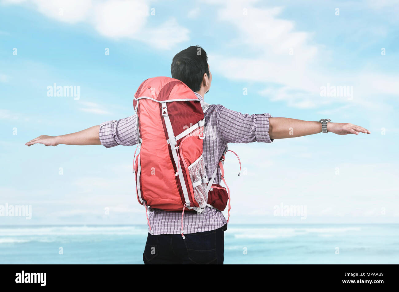 Back view of asian tourist relax and enjoying seascape with blue sky ...