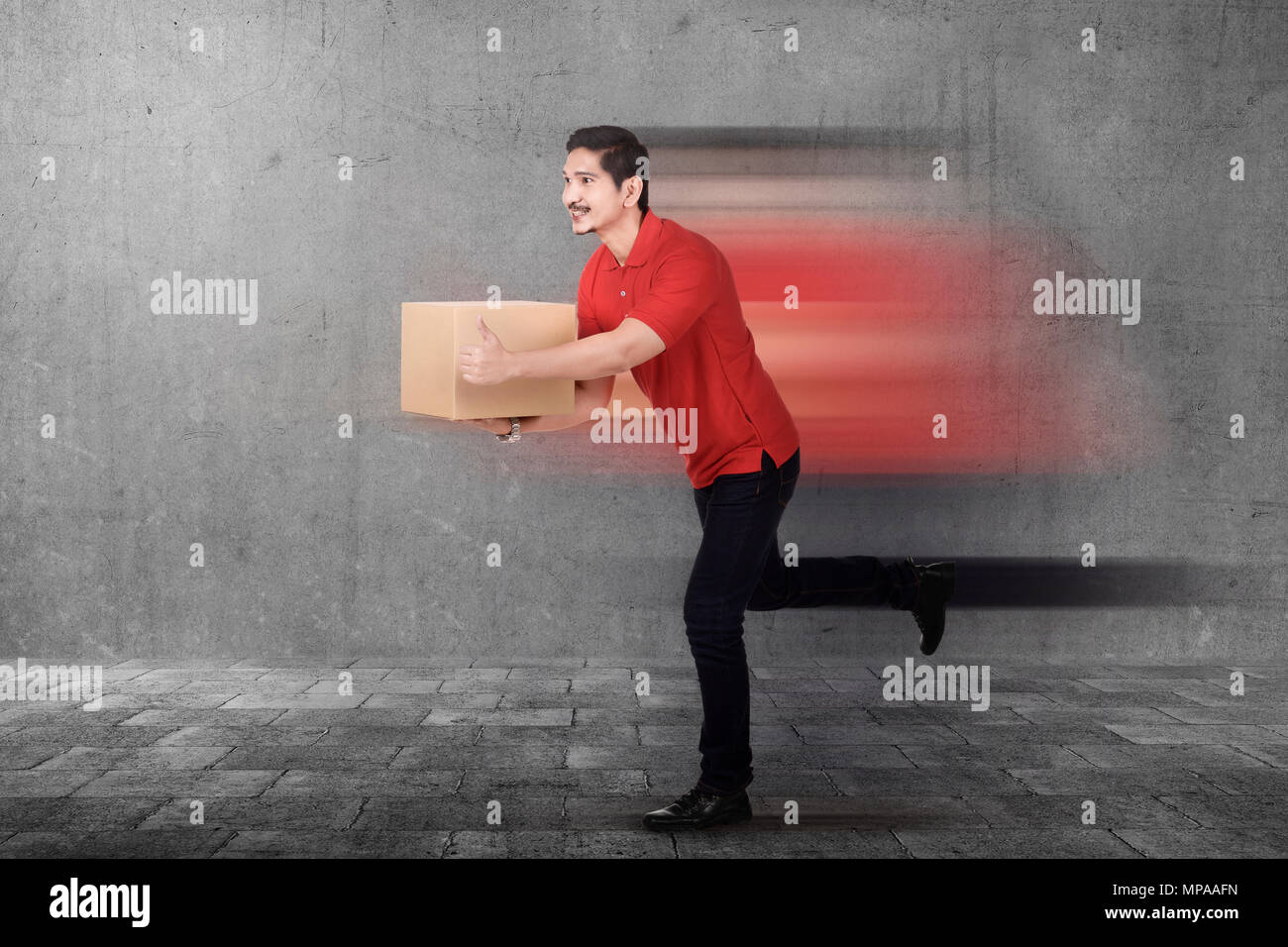 Handsome asian courier man delivering package on the urban street Stock ...