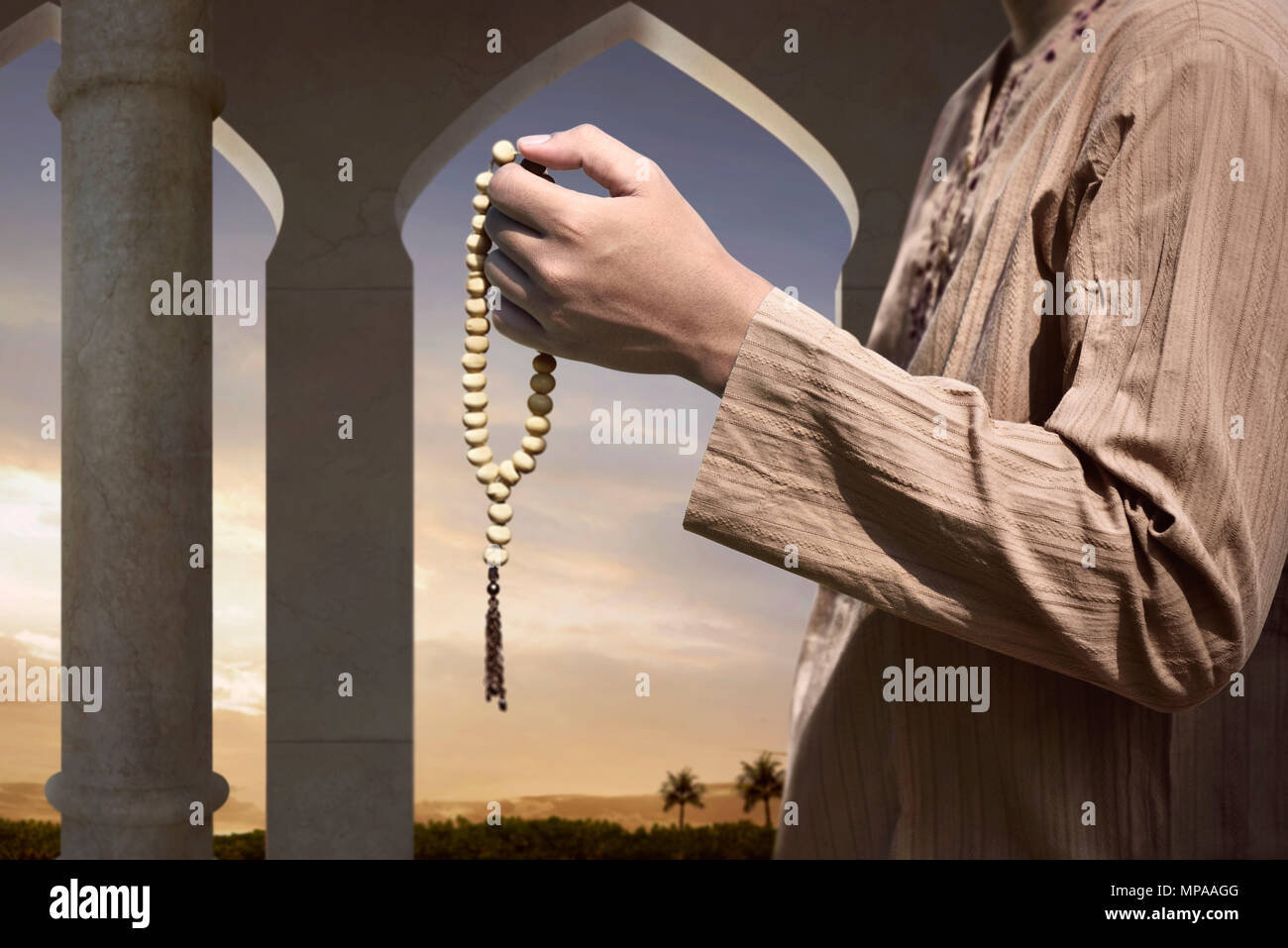 Muslim man praying with prayer beads on the mosque Stock Photo - Alamy