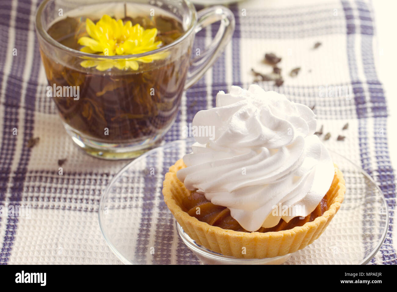 Herbal tea in glass cup and flowers on wooden table Stock Photo - Alamy