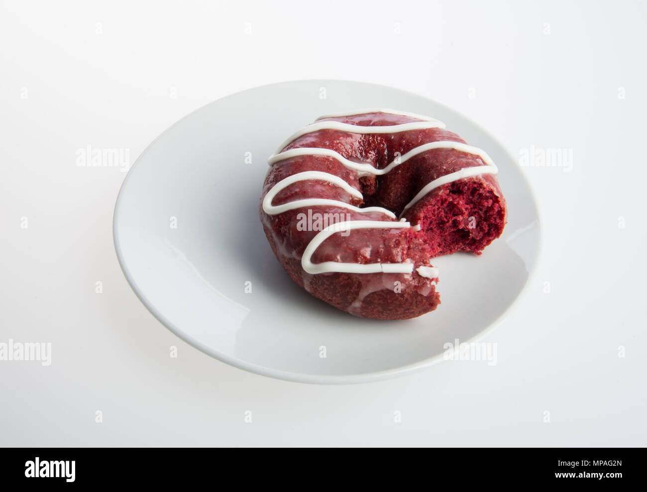 donut or donut with missing bite on a background Stock Photo - Alamy