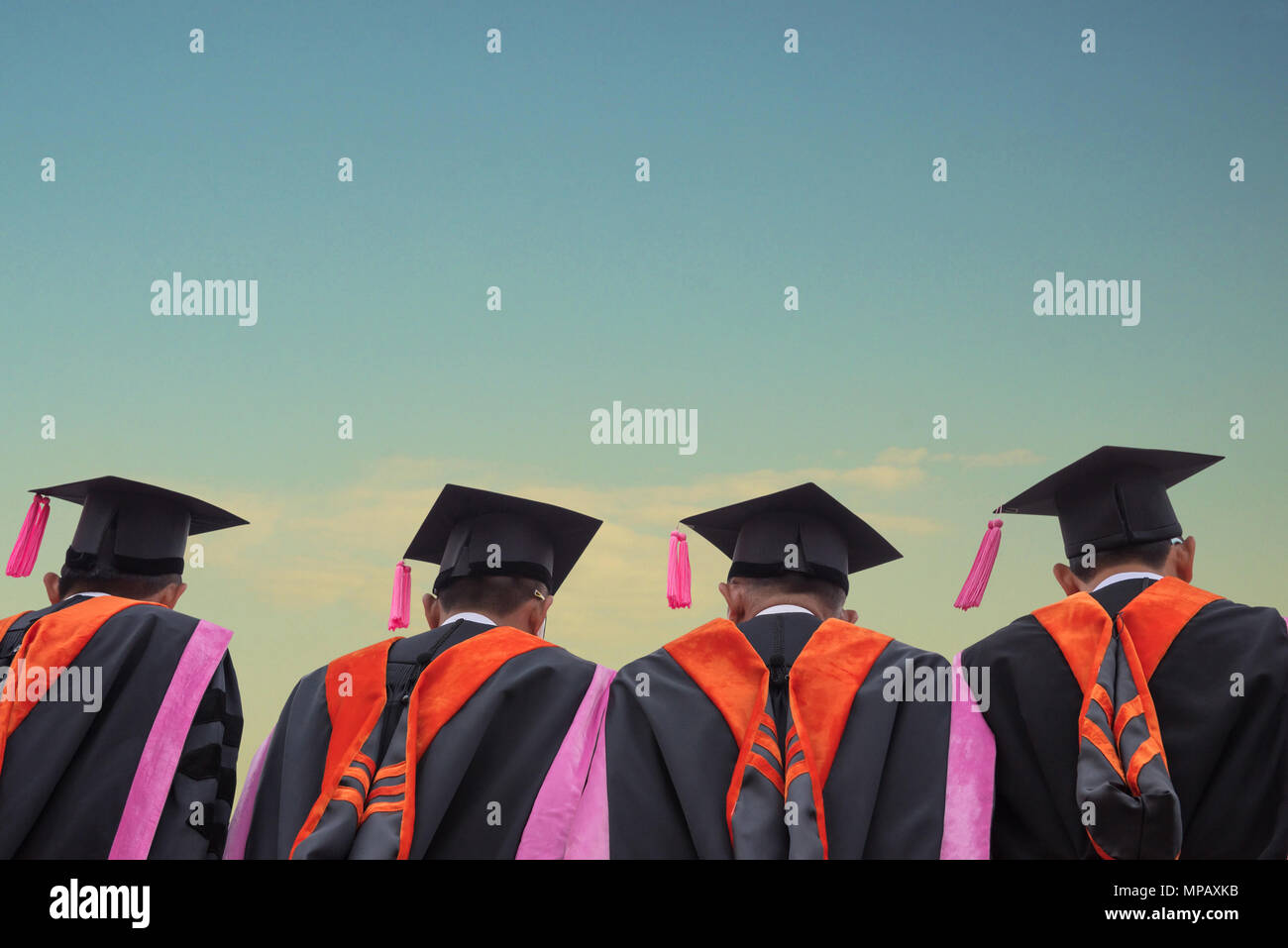 graduates cap behind clear blue sky,Graduates are stand up in line On ...