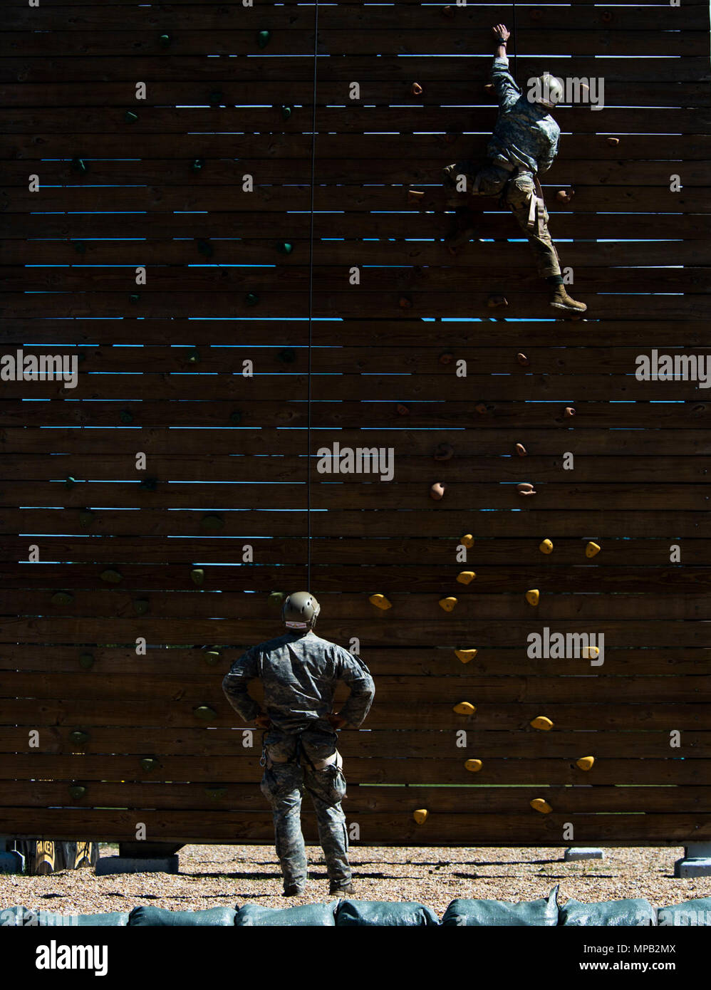 U.S. Army Rangers climb a rock wall at an obstacle course during the ...