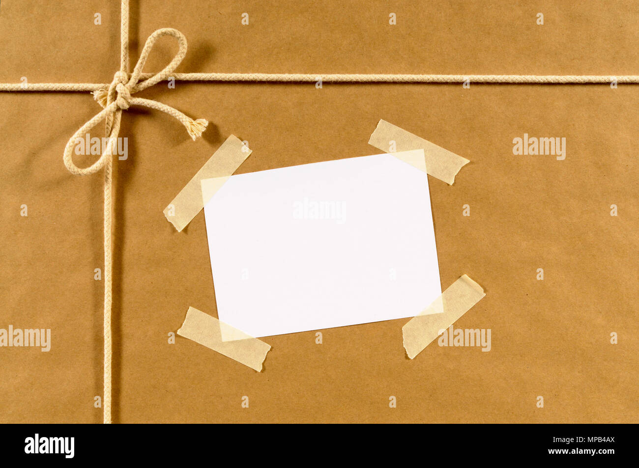Brown paper parcel with rope and untidy address label Stock Photo - Alamy