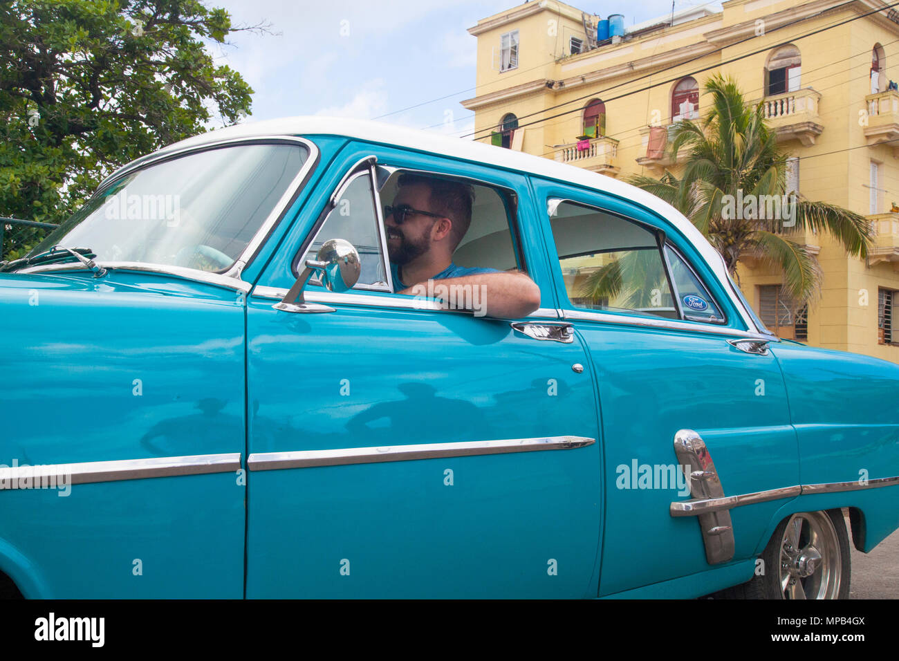 Tourist man driving in Classic Ford car in Havana Cuba Stock Photo - Alamy