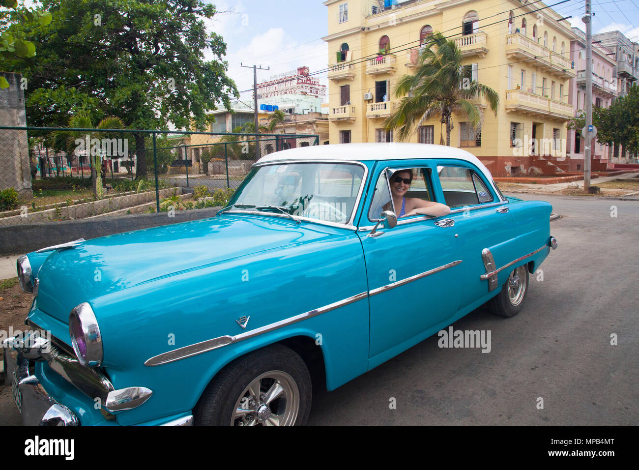 Tourist woman driving a Classic Ford car in Havana Cuba Stock Photo - Alamy