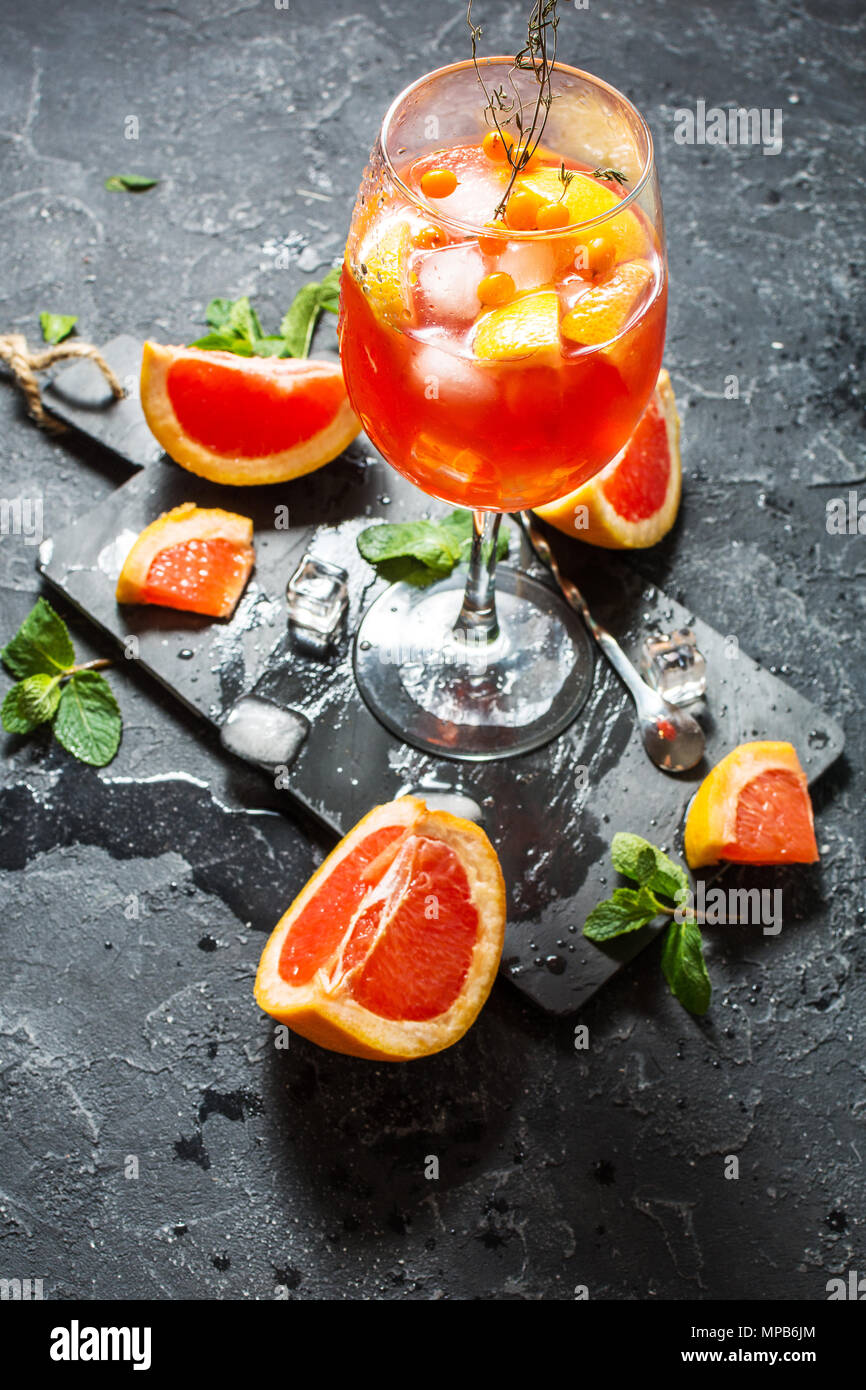 Cocktail drink on stone board. Alcoholic beverage with grapefruit and ...