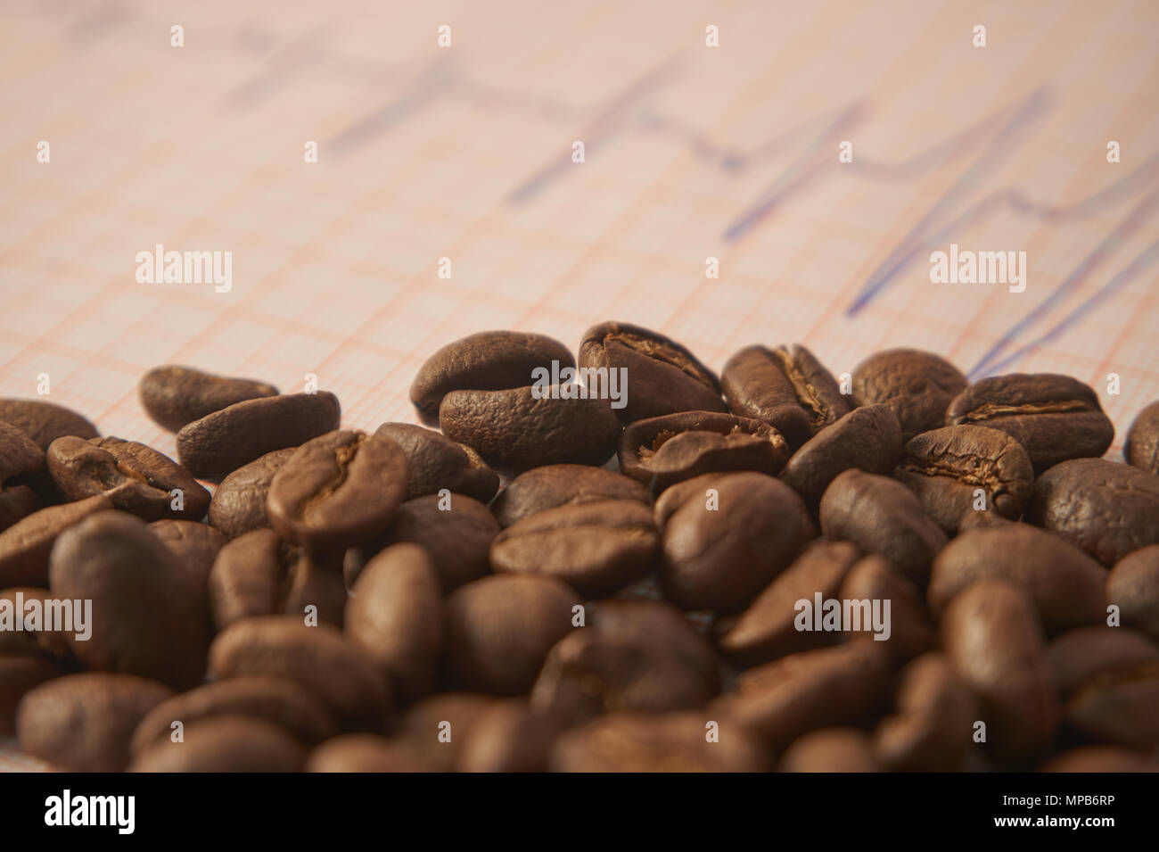 Loose roasted coffee beans on an ECG tracing showing an increased heart ...