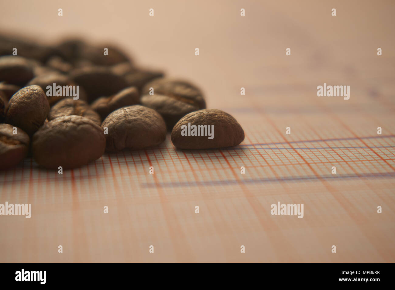 Loose roasted coffee beans on an ECG tracing showing an increased heart ...