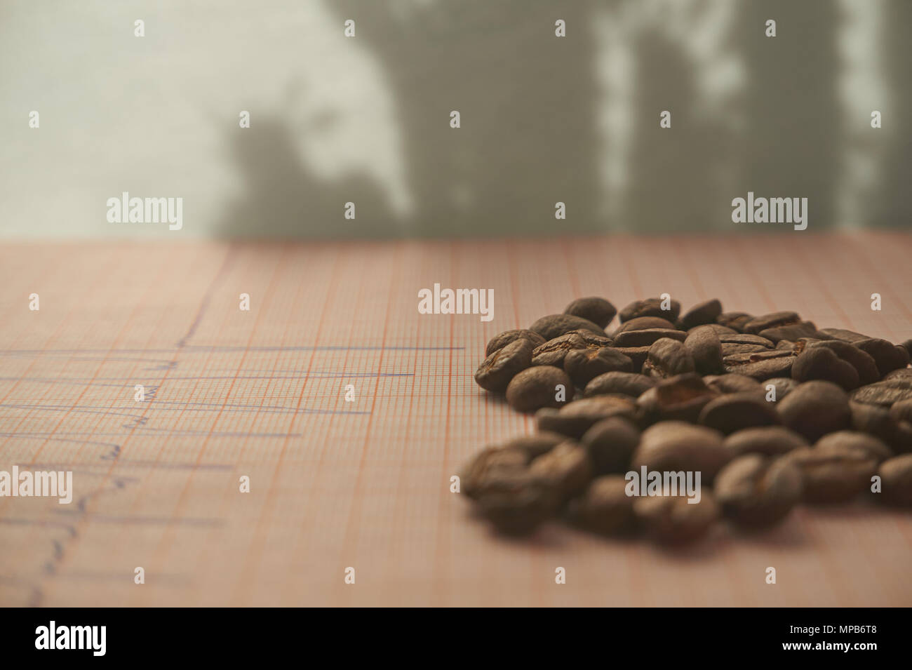 Loose roasted coffee beans on an ECG tracing showing an increased heart ...
