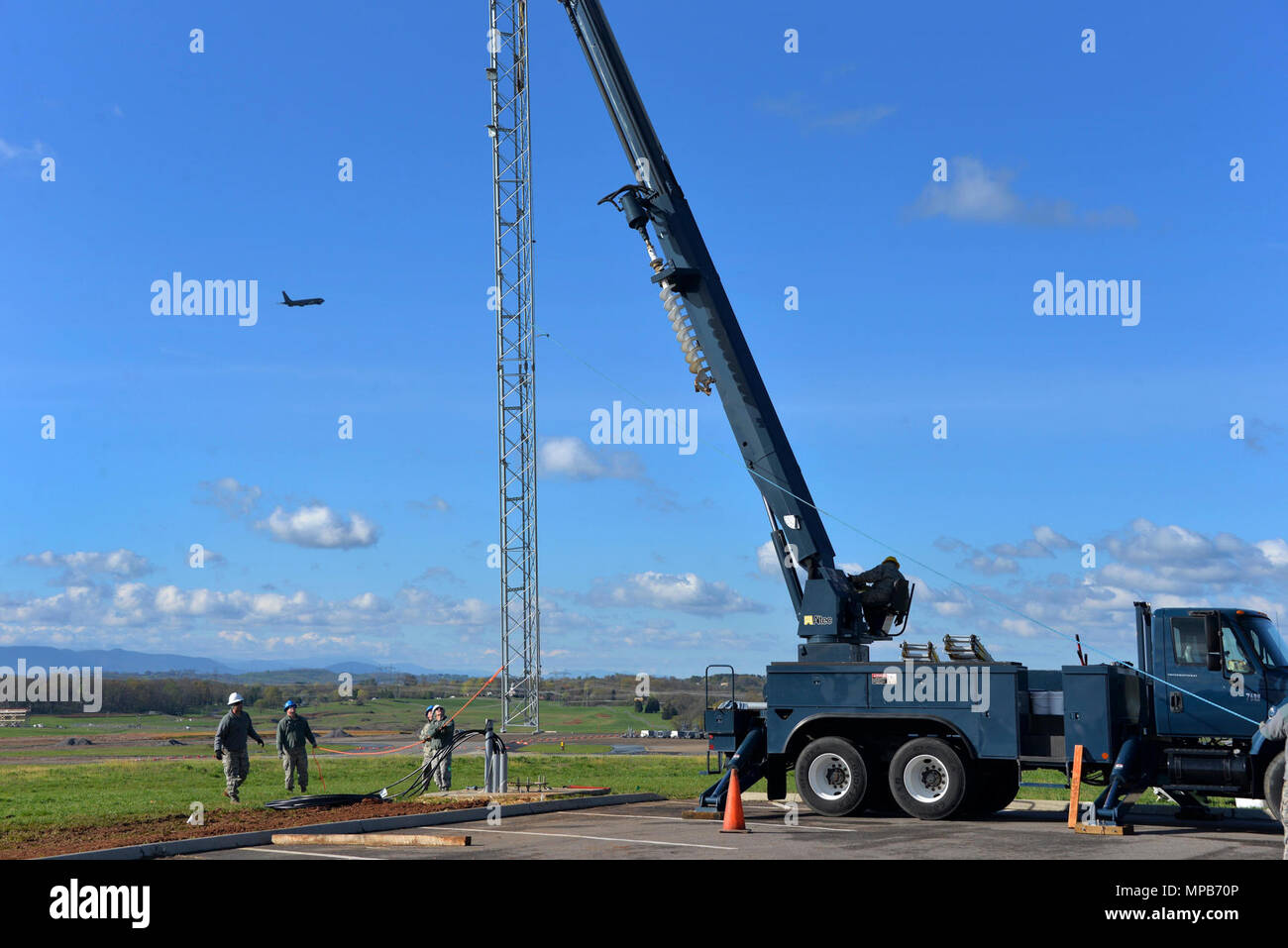 Members of the 241st Engineer Installation Squadron help to erect a ...