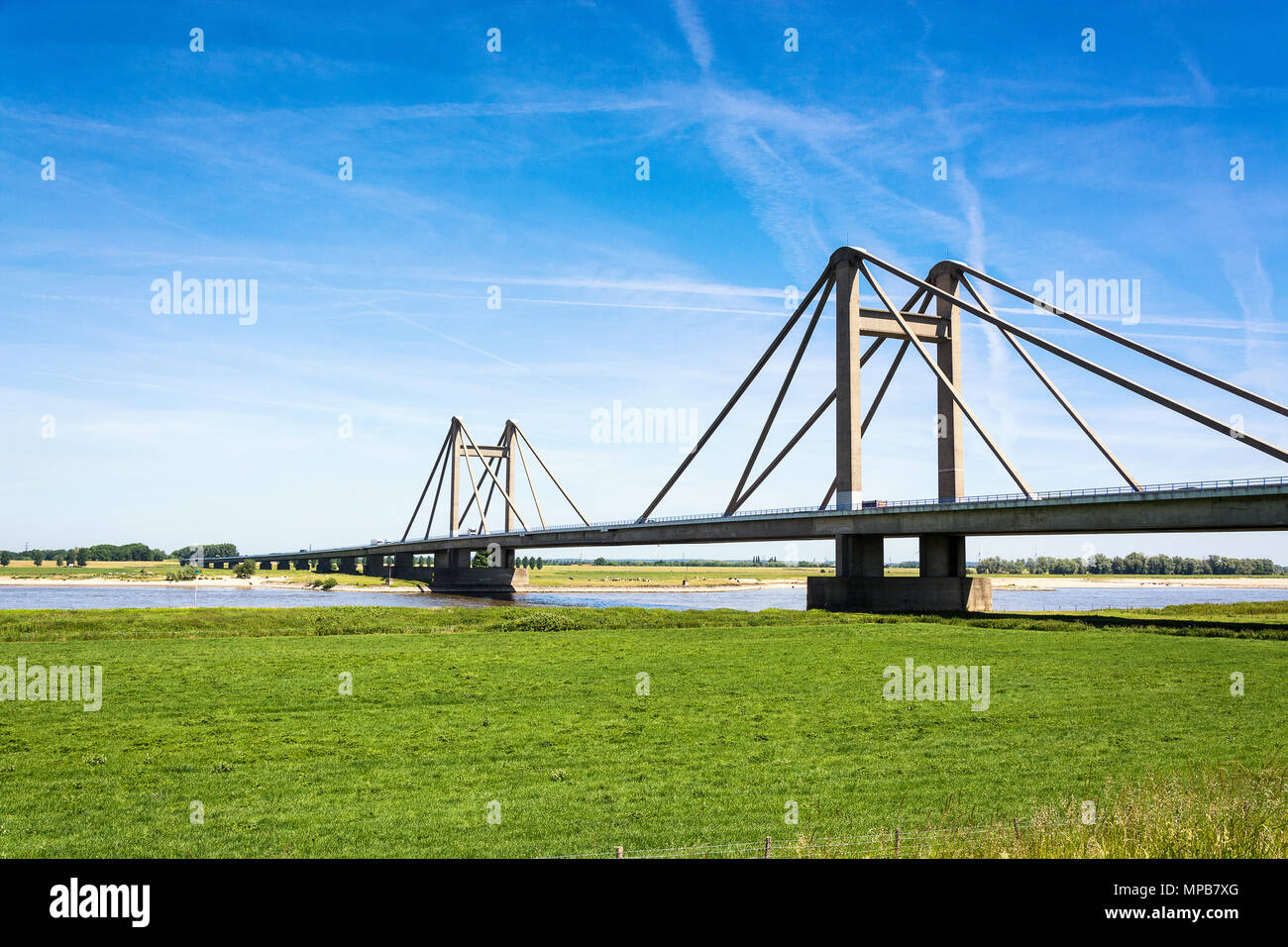 Dutch landscape with bridge over the river Waal in the Netherlands ...