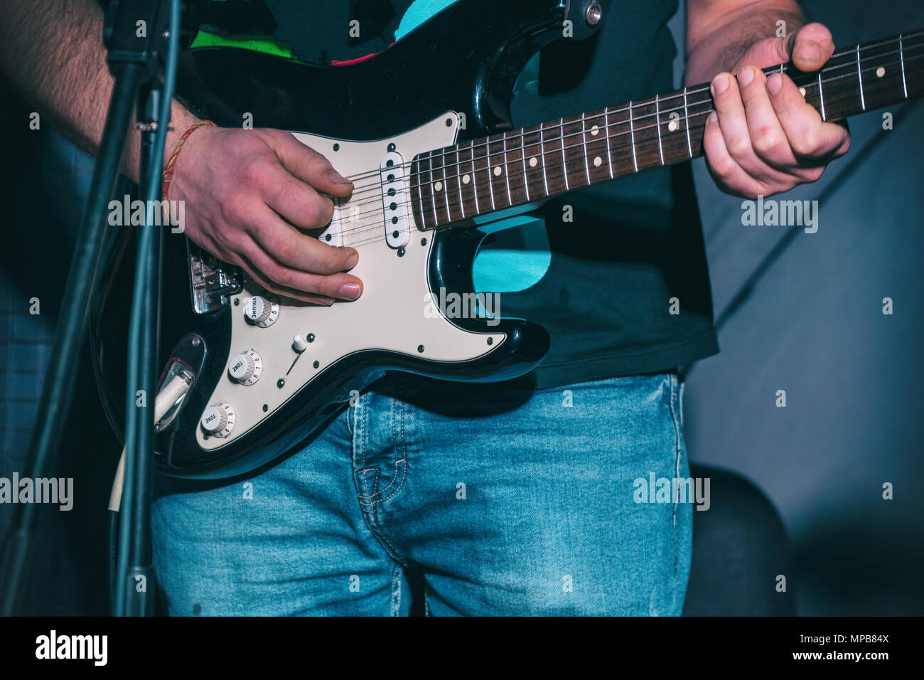 Guitarist man playing electric guitar Stock Photo - Alamy