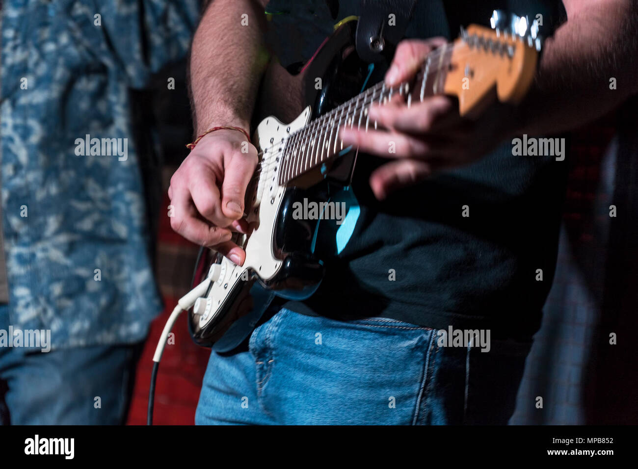 Guitarist man playing electric guitar Stock Photo - Alamy