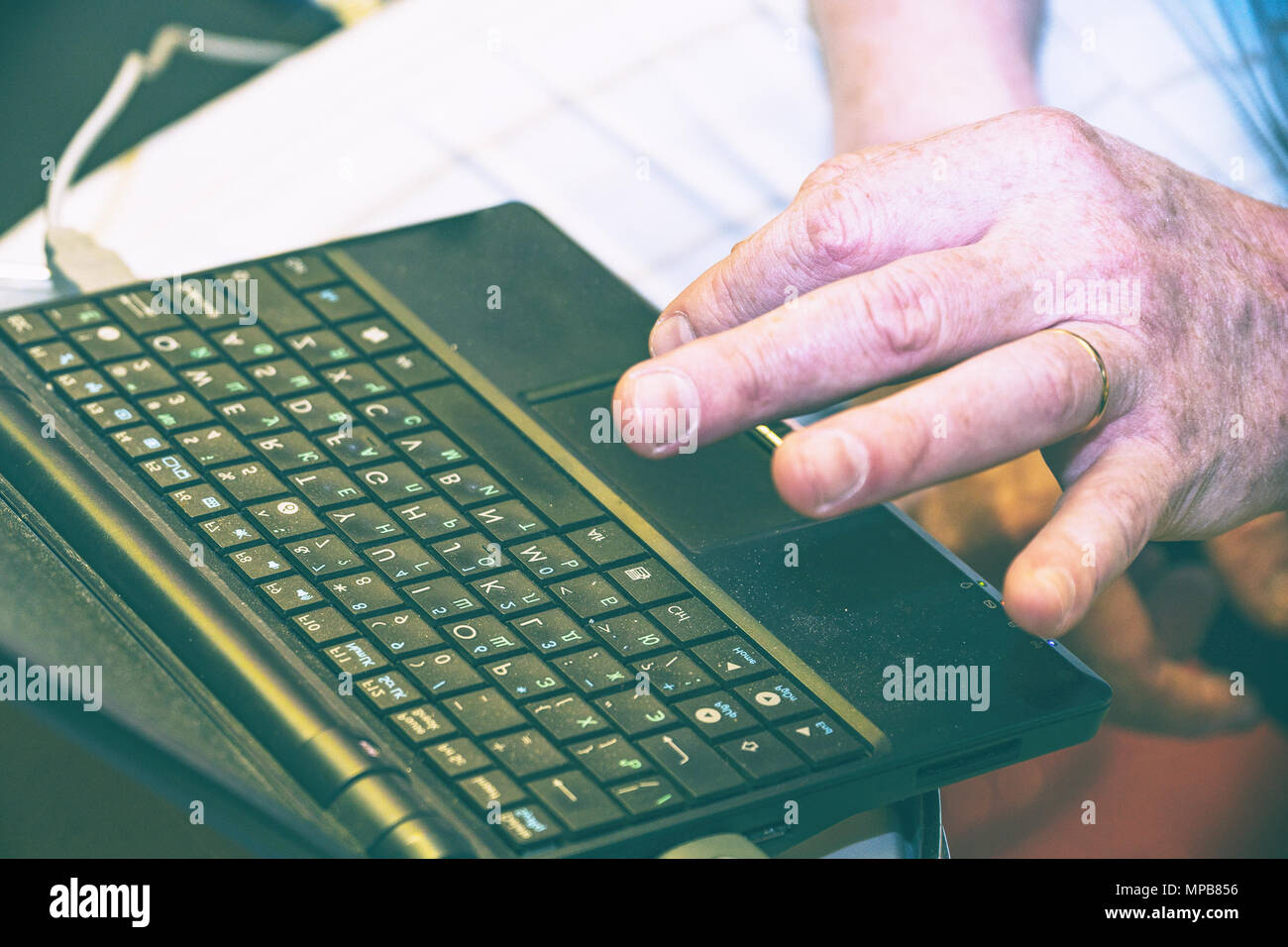 Male hand over keyboard of the laptop Stock Photo - Alamy